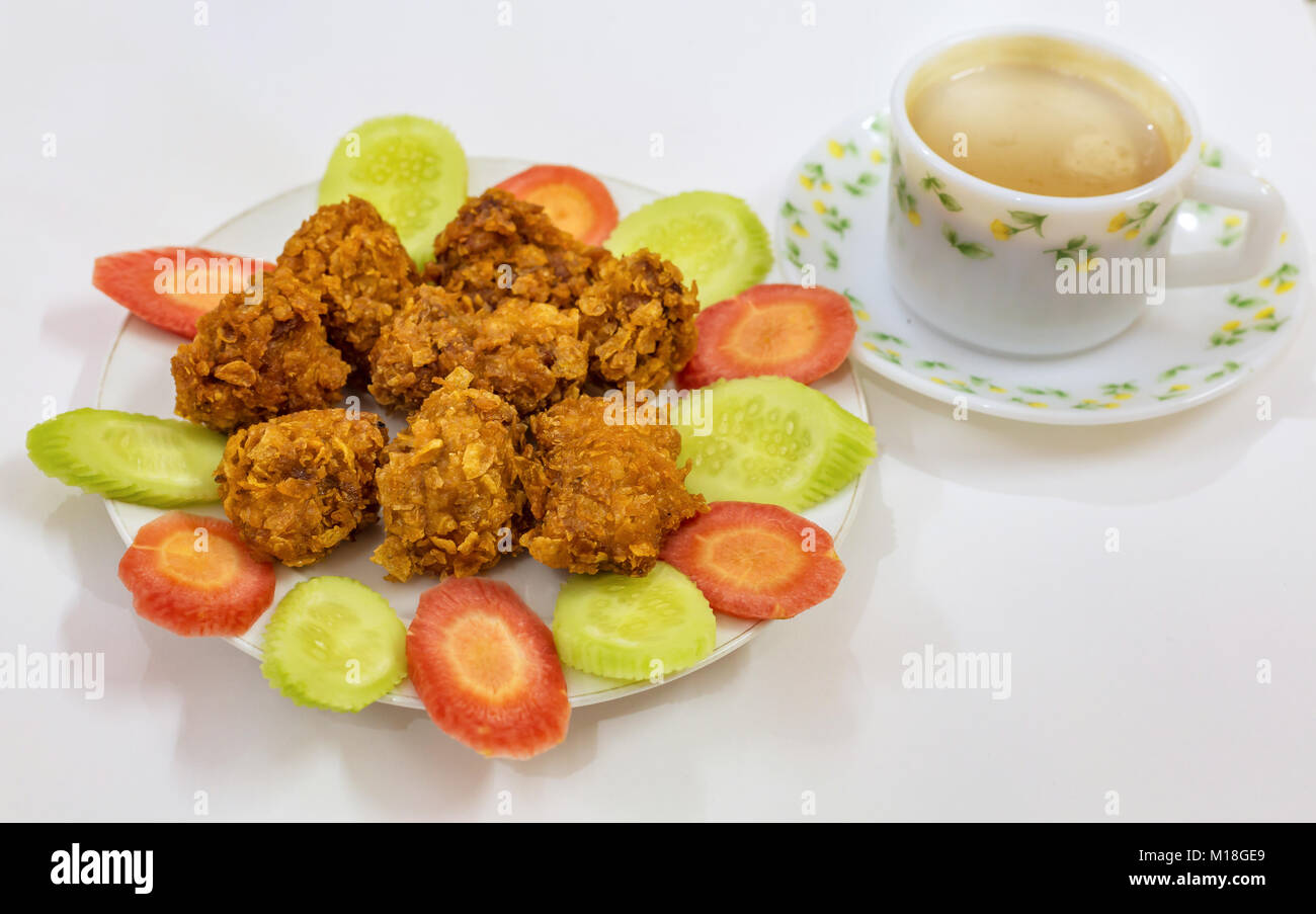Crispy deep fried chicken pakora garnished with sliced carrots and ...