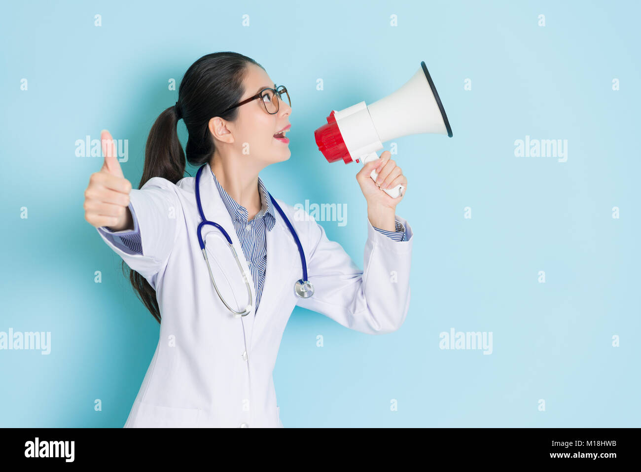 happy attractive woman doctor using loudspeaker announcing medical ...