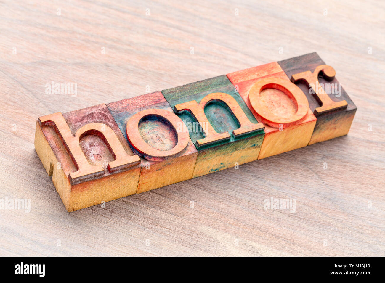 honor word abstract in letterpress wood type printing blocks stained by ...