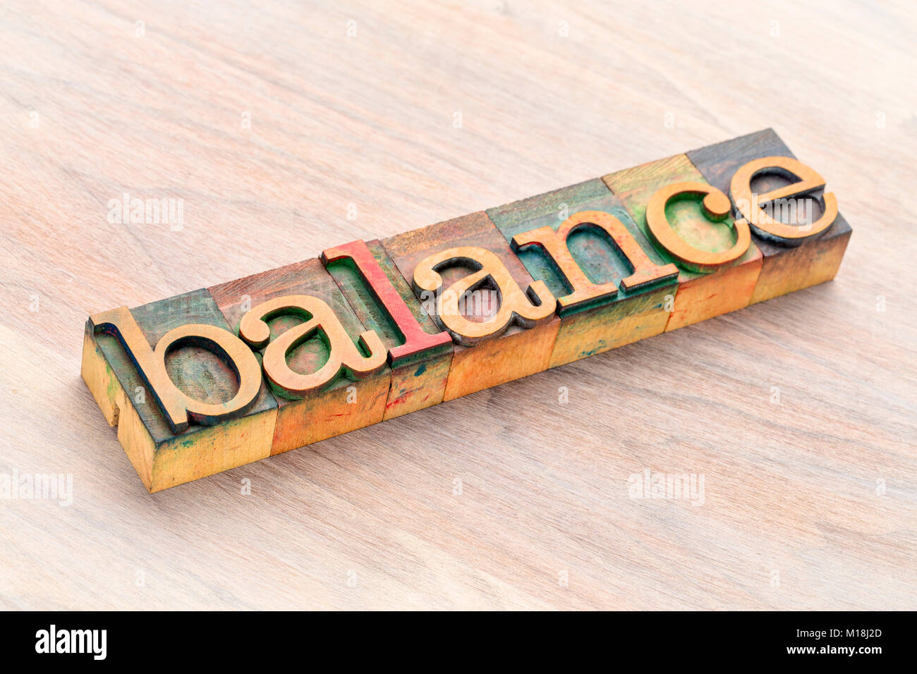 balance word abstract in letterpress wood type blocks stained by color ...
