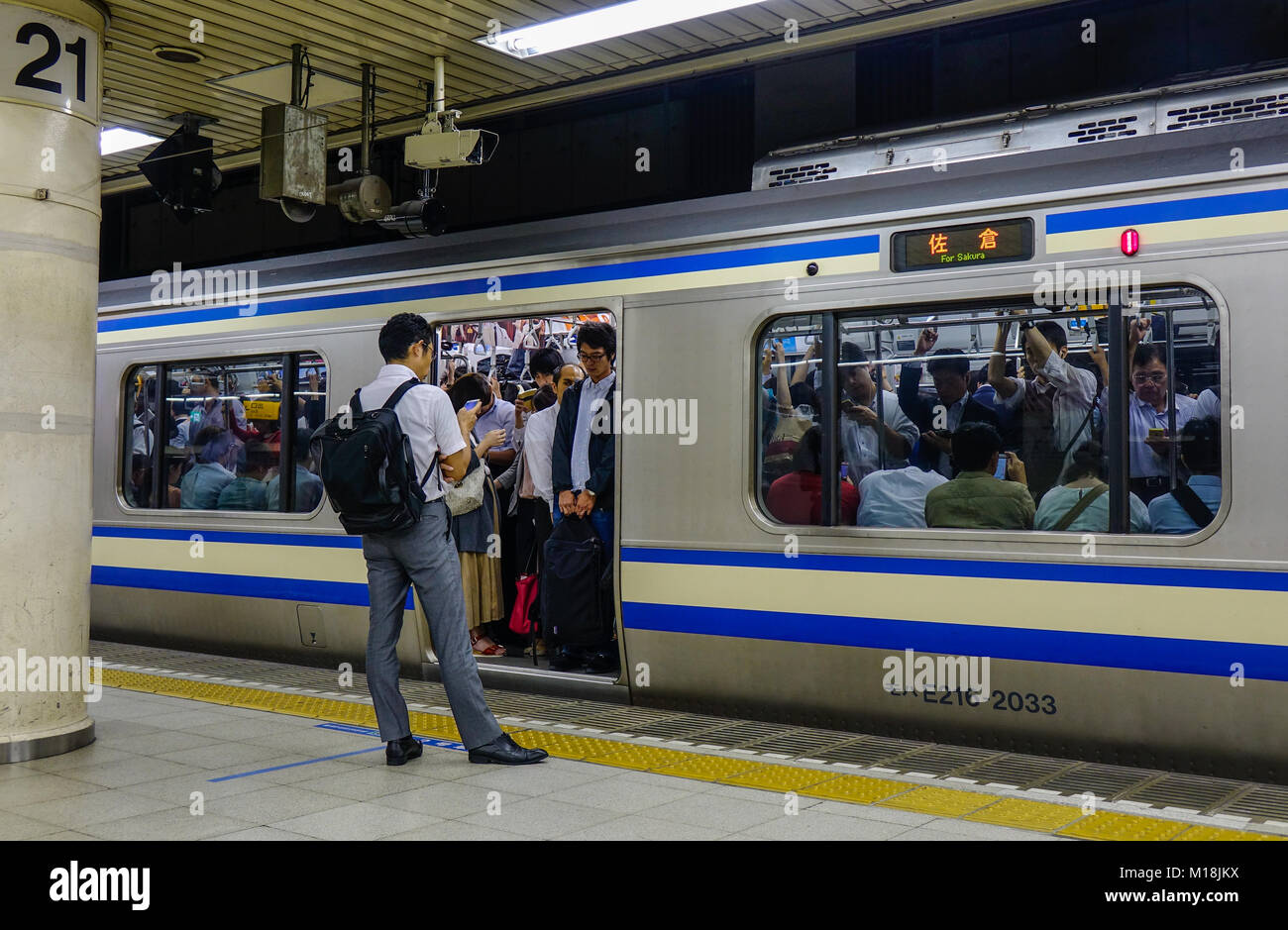 Crowd of people standing on busy station platform hi-res stock ...