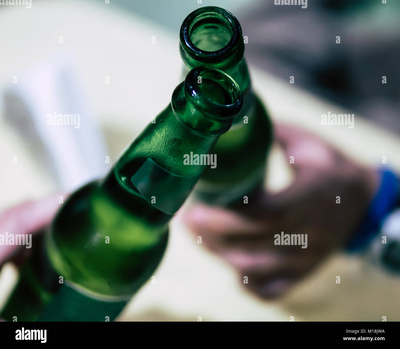 Close up of two people with beer bottles toasting cheers Stock Photo ...