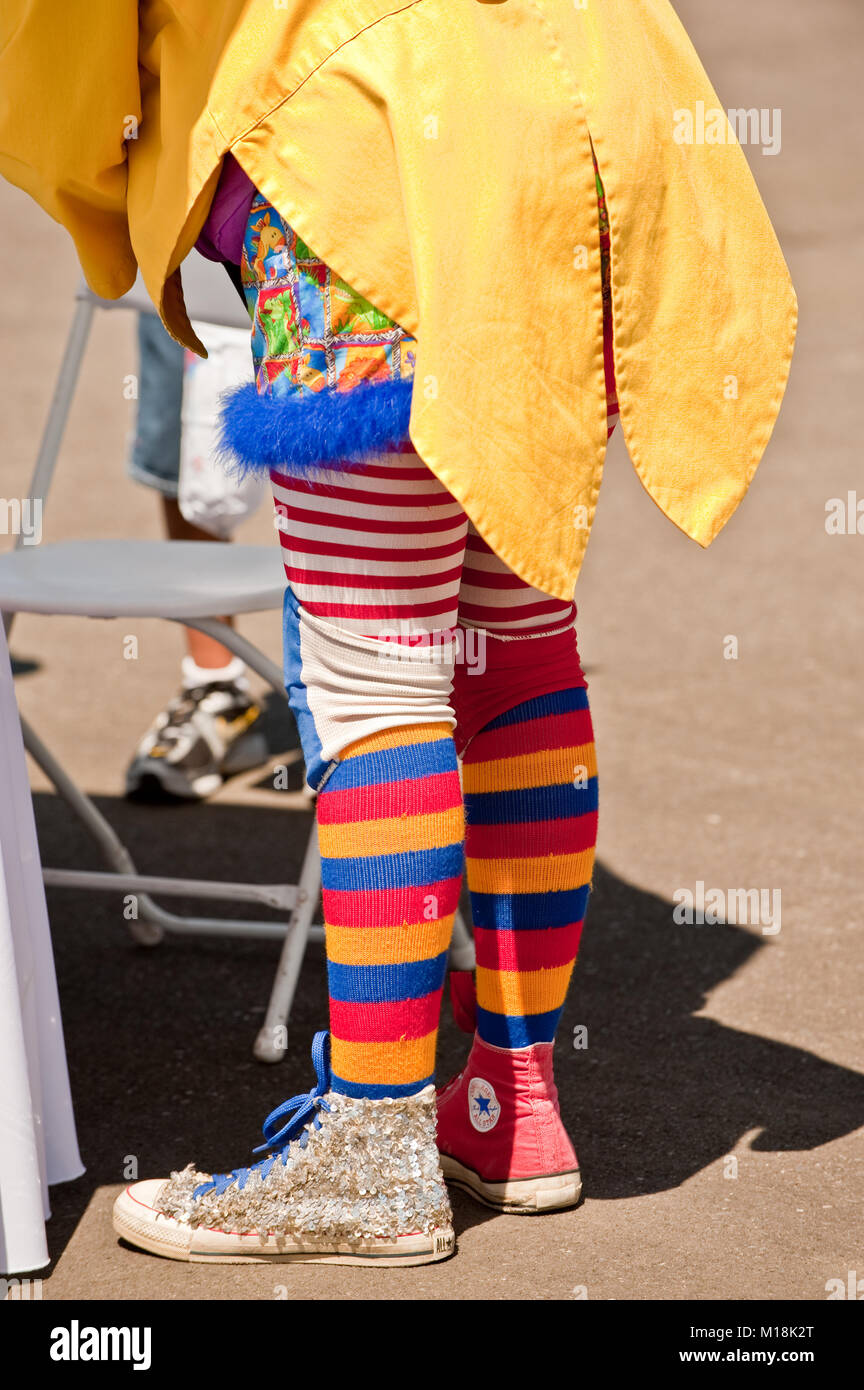 Rear view of a clown with colorful socks in a yellow jacket Stock Photo ...