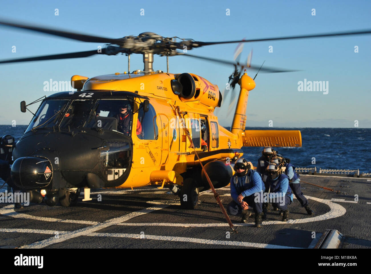 A helicopter crew from Coast Guard Air Station Cape Cod, in ...