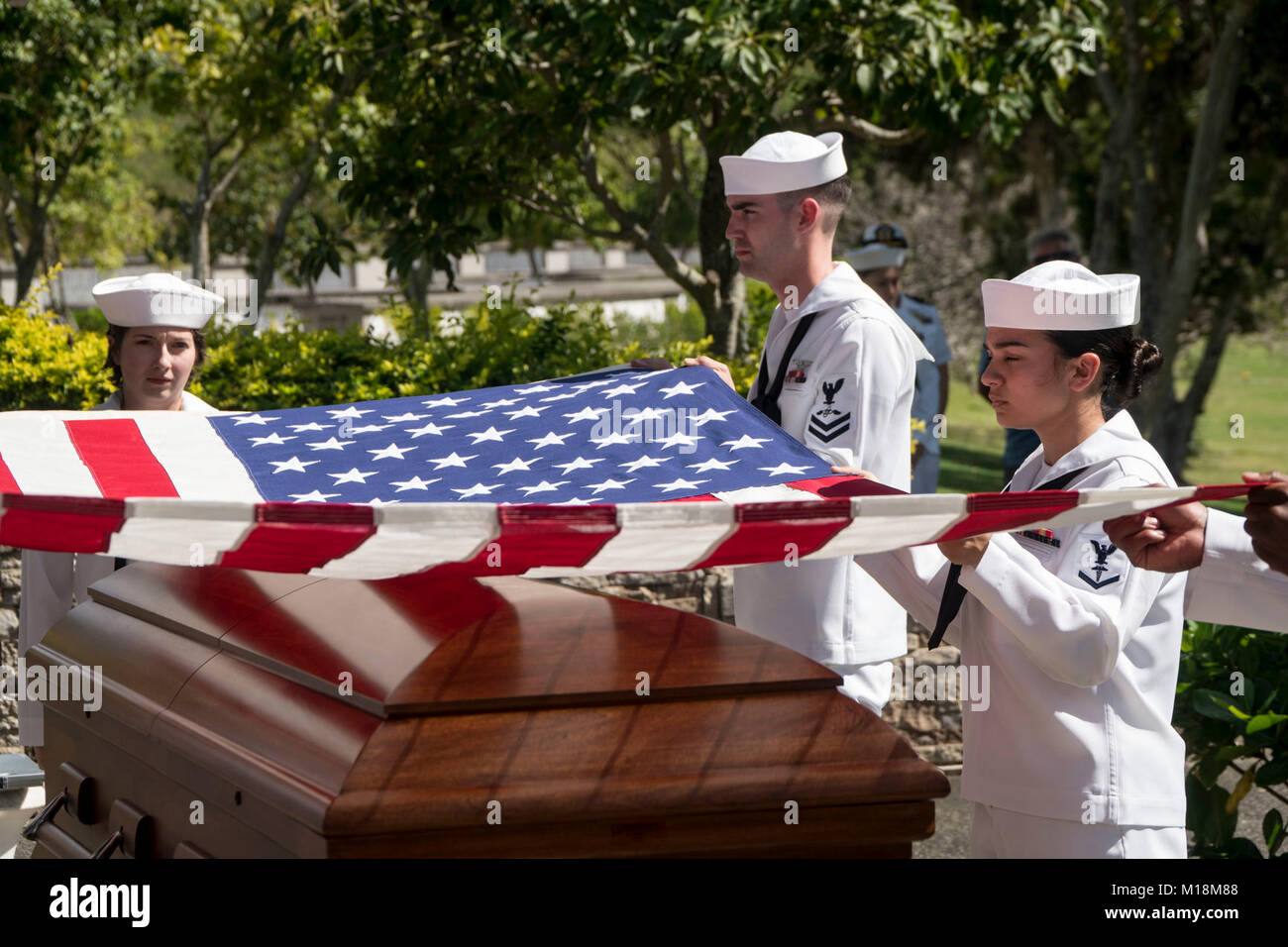U.S. Sailors of Navy Region Hawaii fold the American flag over the ...