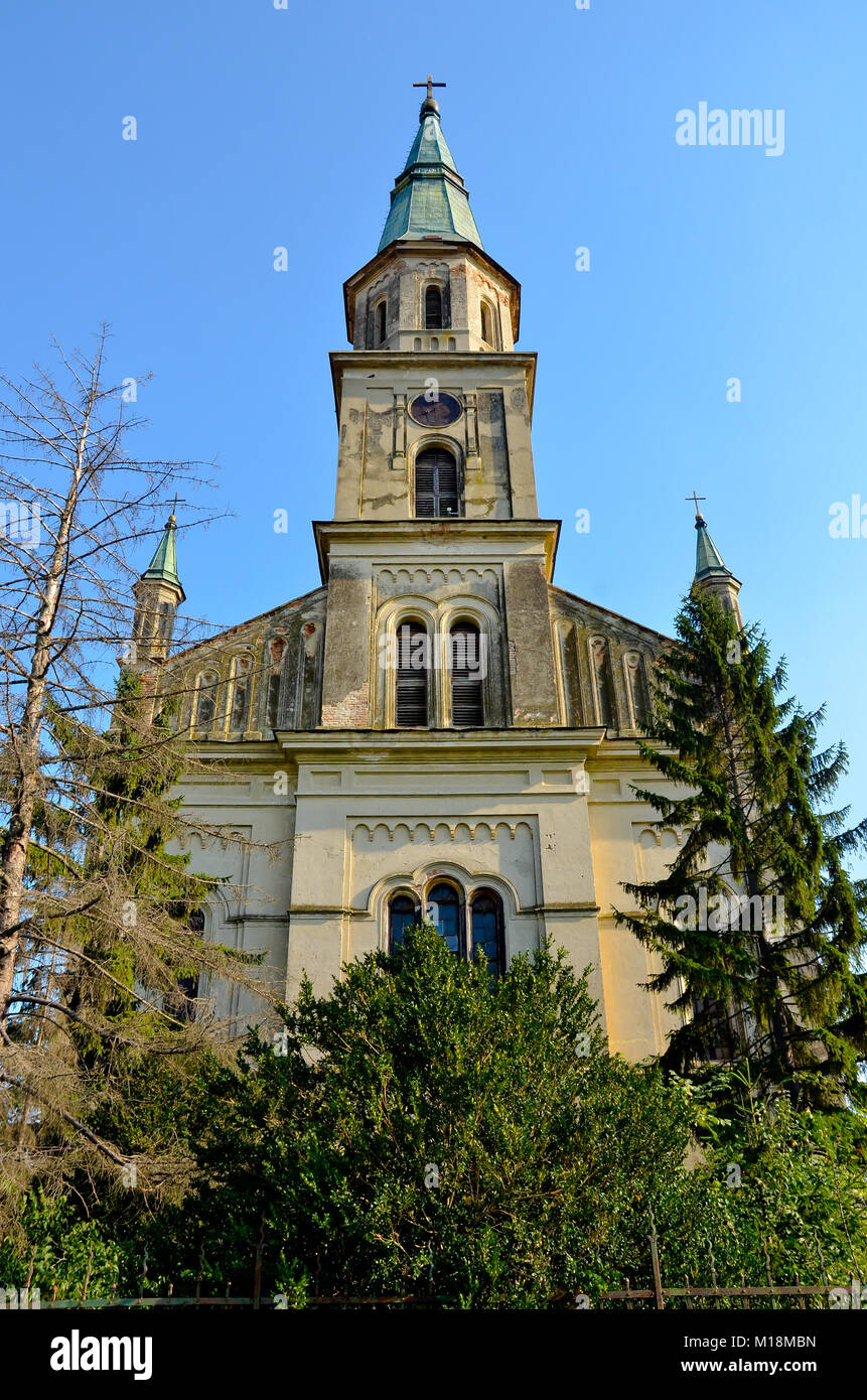 old church on clear blue sky with trees around, front view Stock Photo ...