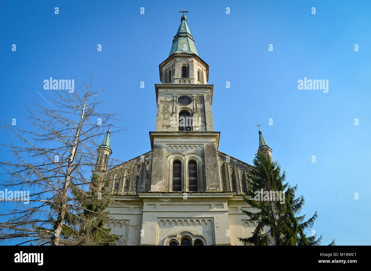 old church on clear blue sky with trees around, front view Stock Photo ...