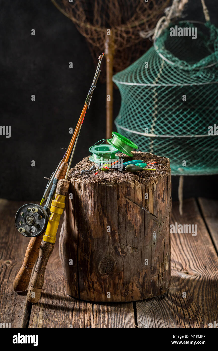 Old angler equipment with net, rods and floats Stock Photo - Alamy