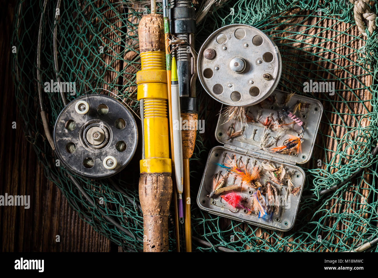 Angler equipment with fishing flies and rods Stock Photo - Alamy