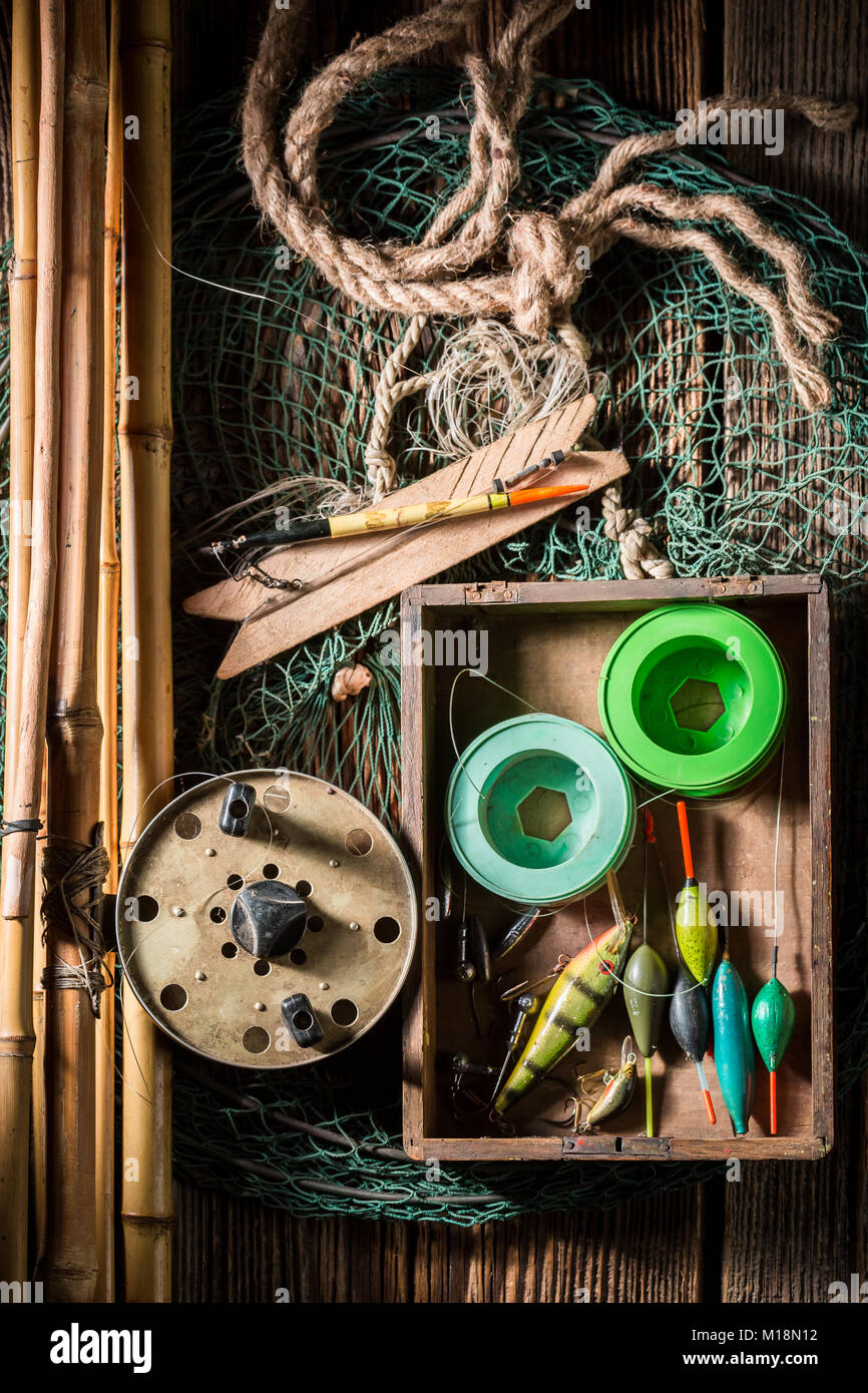 Vintage angler equipment with net, rods and floats Stock Photo - Alamy