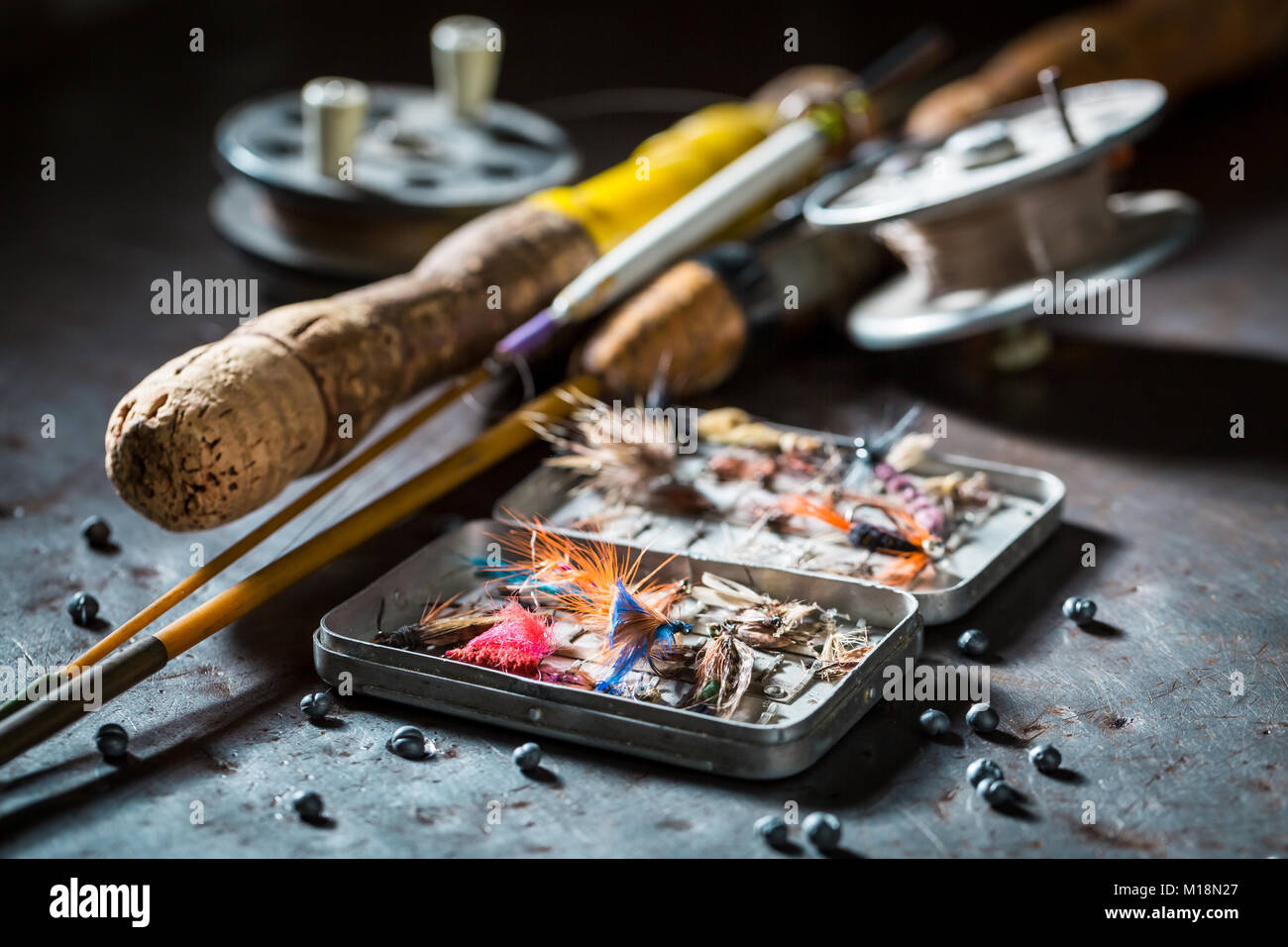 Handmade fishing tackle with fishing flies and rods Stock Photo - Alamy