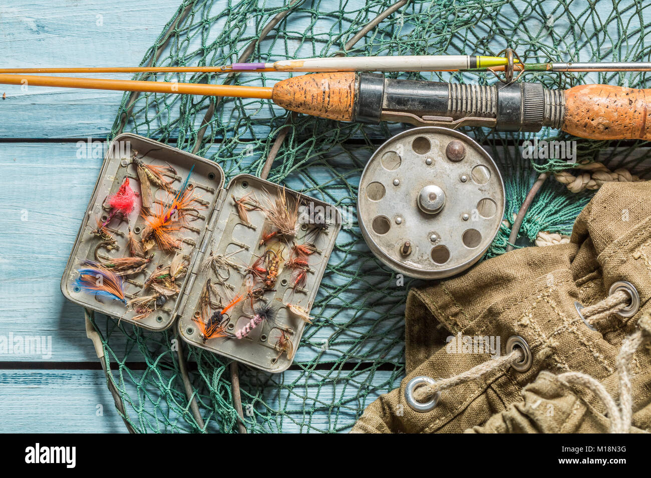 Angler equipment with net, rods and floats Stock Photo - Alamy