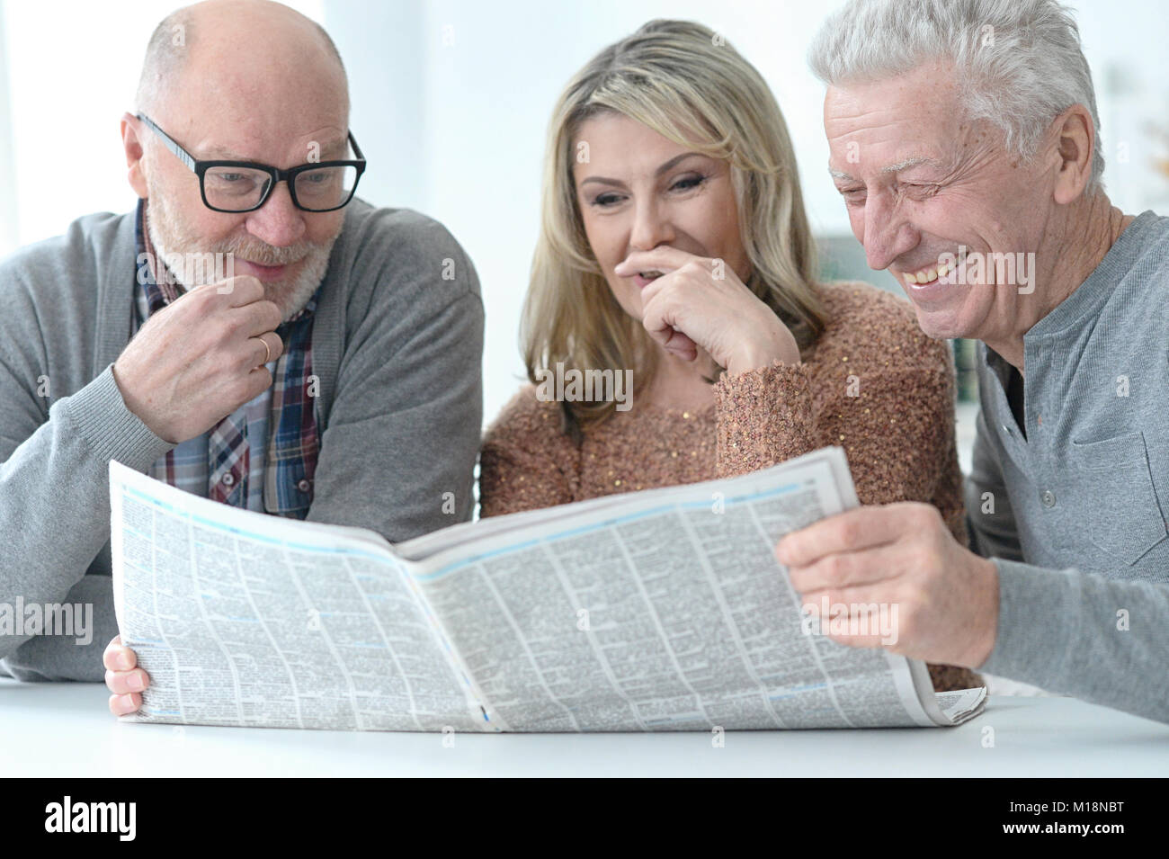 senior people reading newspaper Stock Photo - Alamy