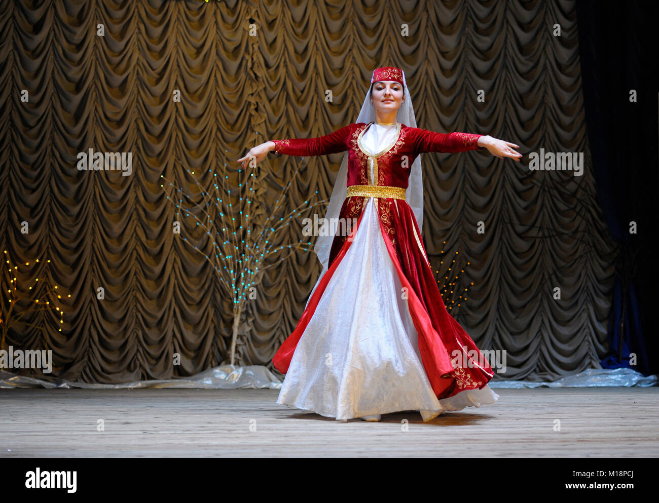 Crimean tatar dancer in a native dress performing native dance on stage ...