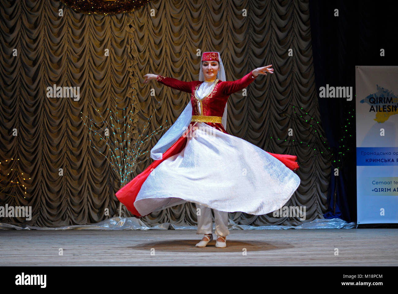 Crimean tatar dancer in a native dress performing native dance on stage ...