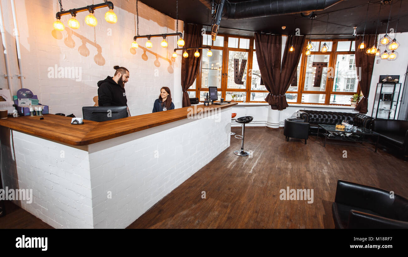Young smiling woman at the reception desk Stock Photo - Alamy
