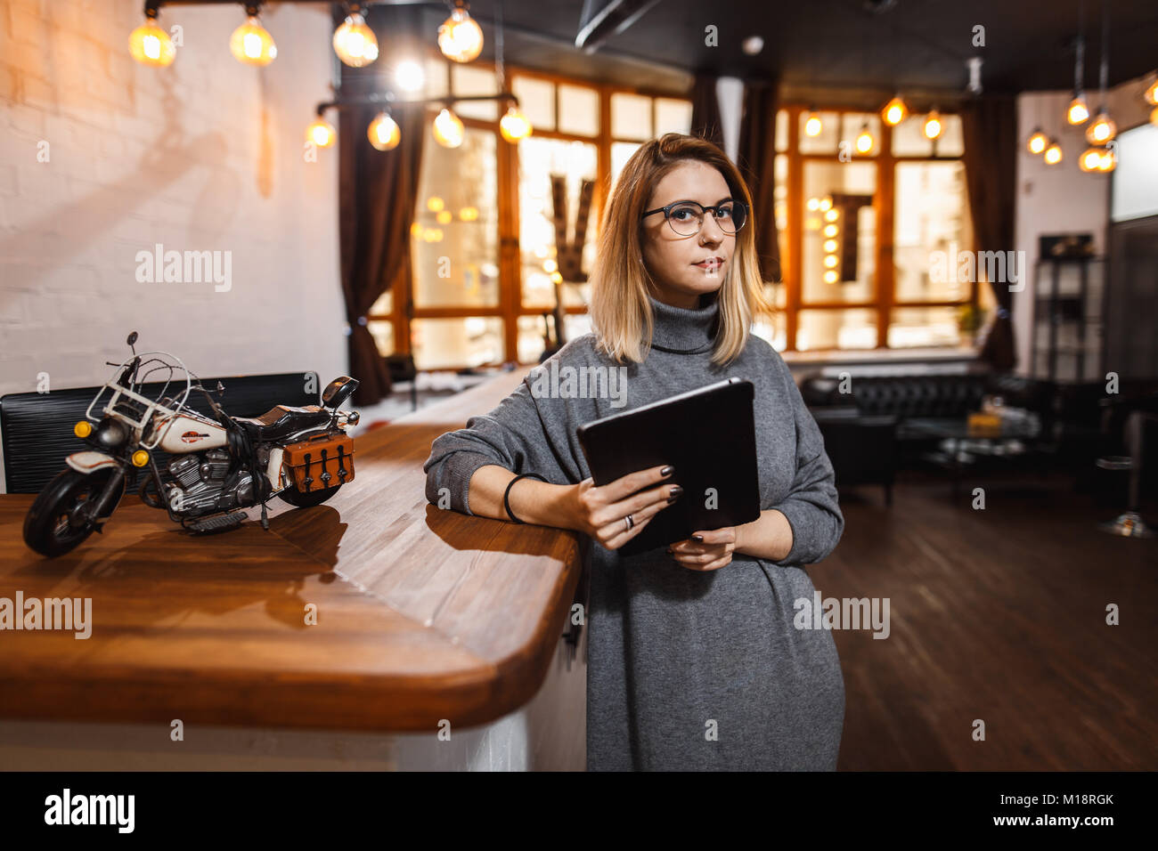Receptionist standing at reception counter in office Stock Photo - Alamy