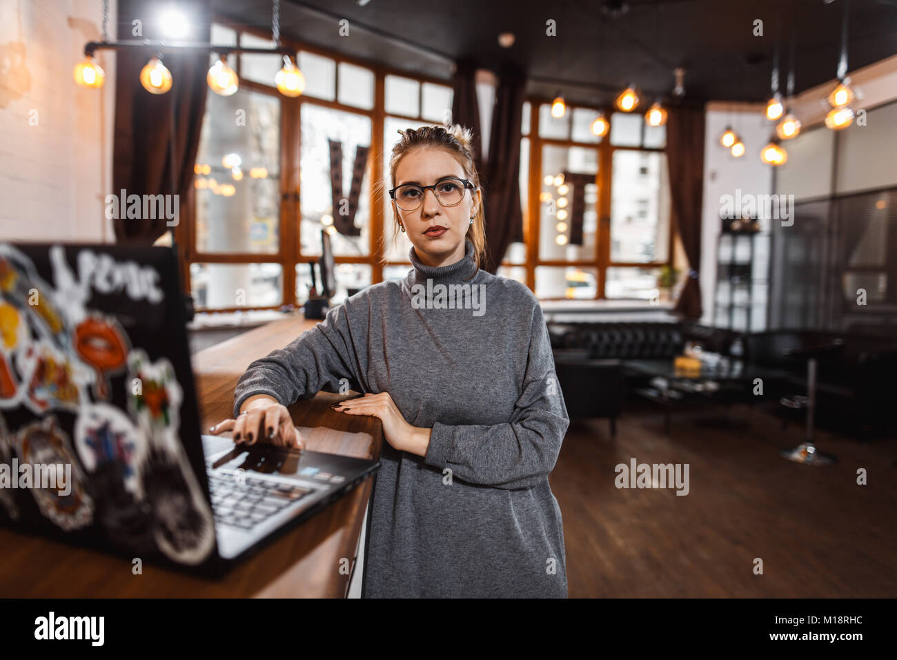 Receptionist standing at reception counter in office Stock Photo - Alamy