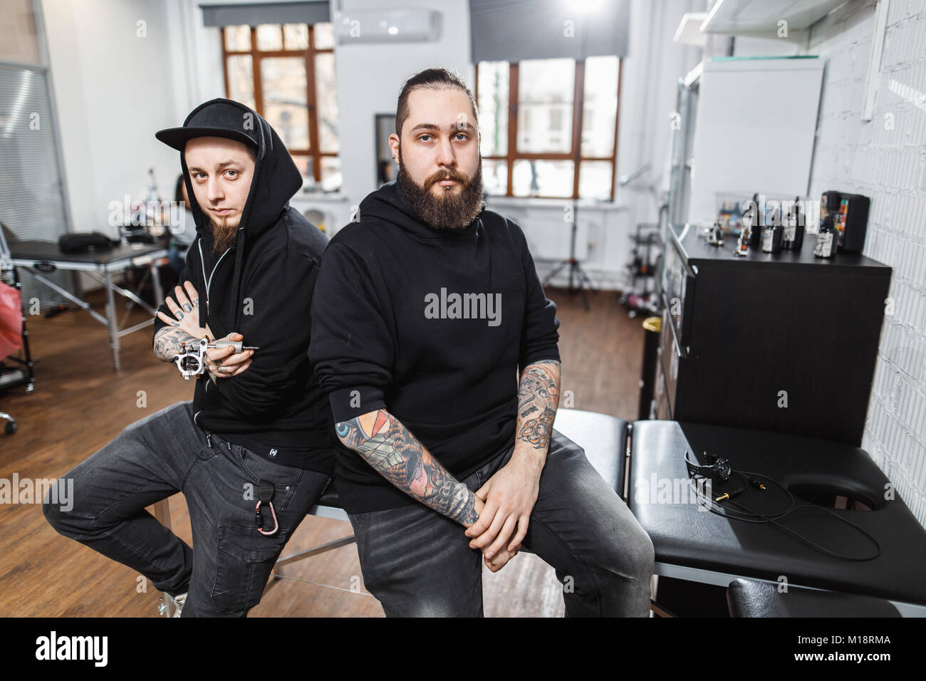 Portrait of two professional creative tattoo masters Stock Photo - Alamy