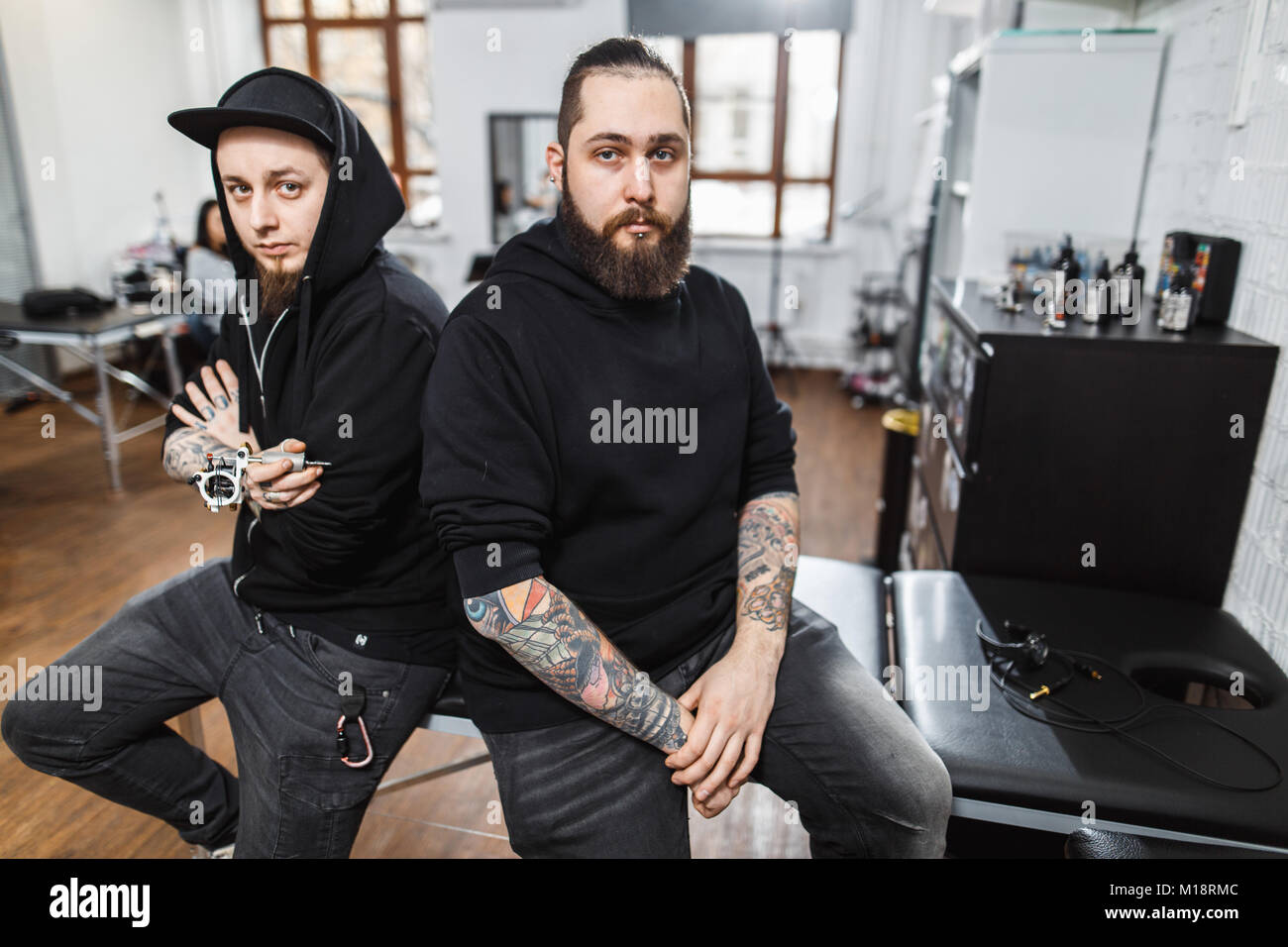 Portrait of two professional creative tattoo masters Stock Photo - Alamy