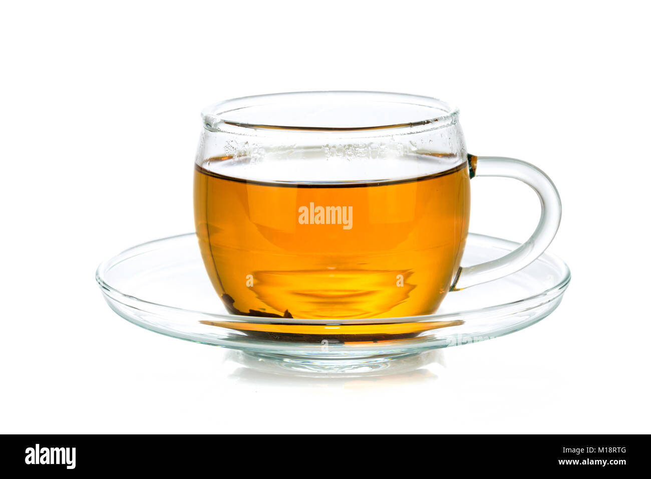 Transparent glass cup of tea isolated on a white background in close-up ...