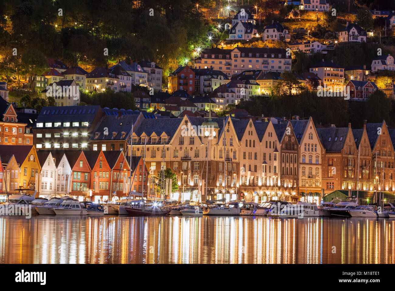 Bergen street at night with boats in Norway, UNESCO World Heritage Site ...