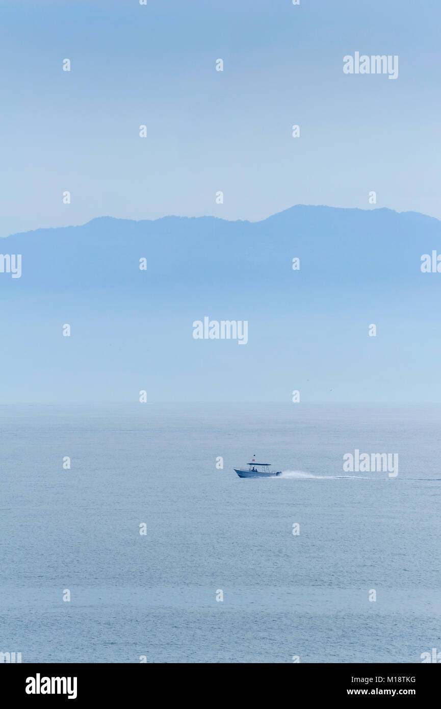 Small motor boat on a vast ocean Stock Photo - Alamy