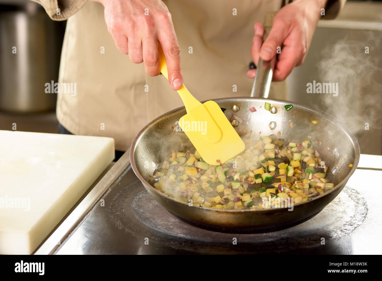 Cook mixing vegetables in bowl hi-res stock photography and images - Alamy