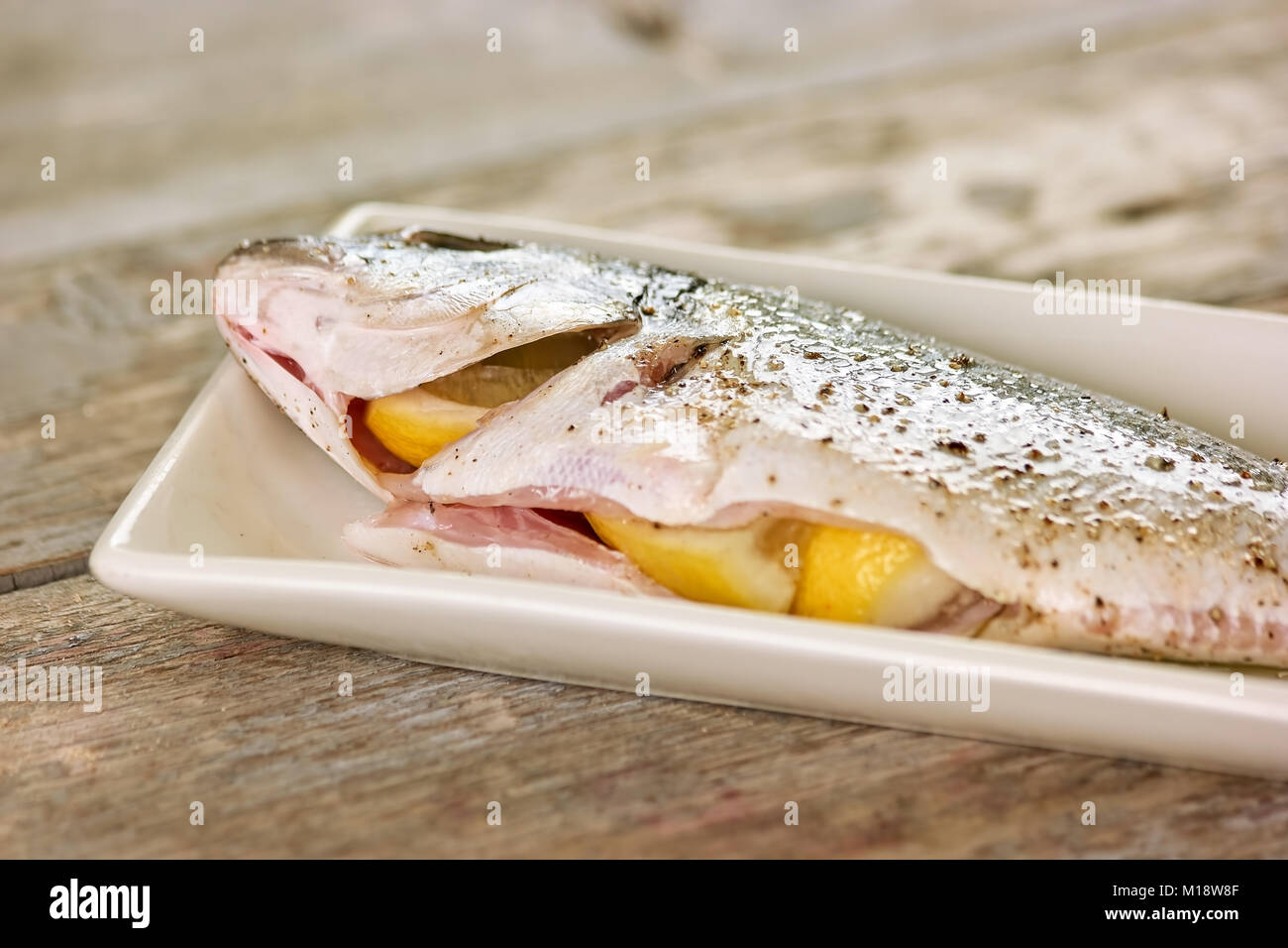 Lemons inside fish closeup Stock Photo - Alamy