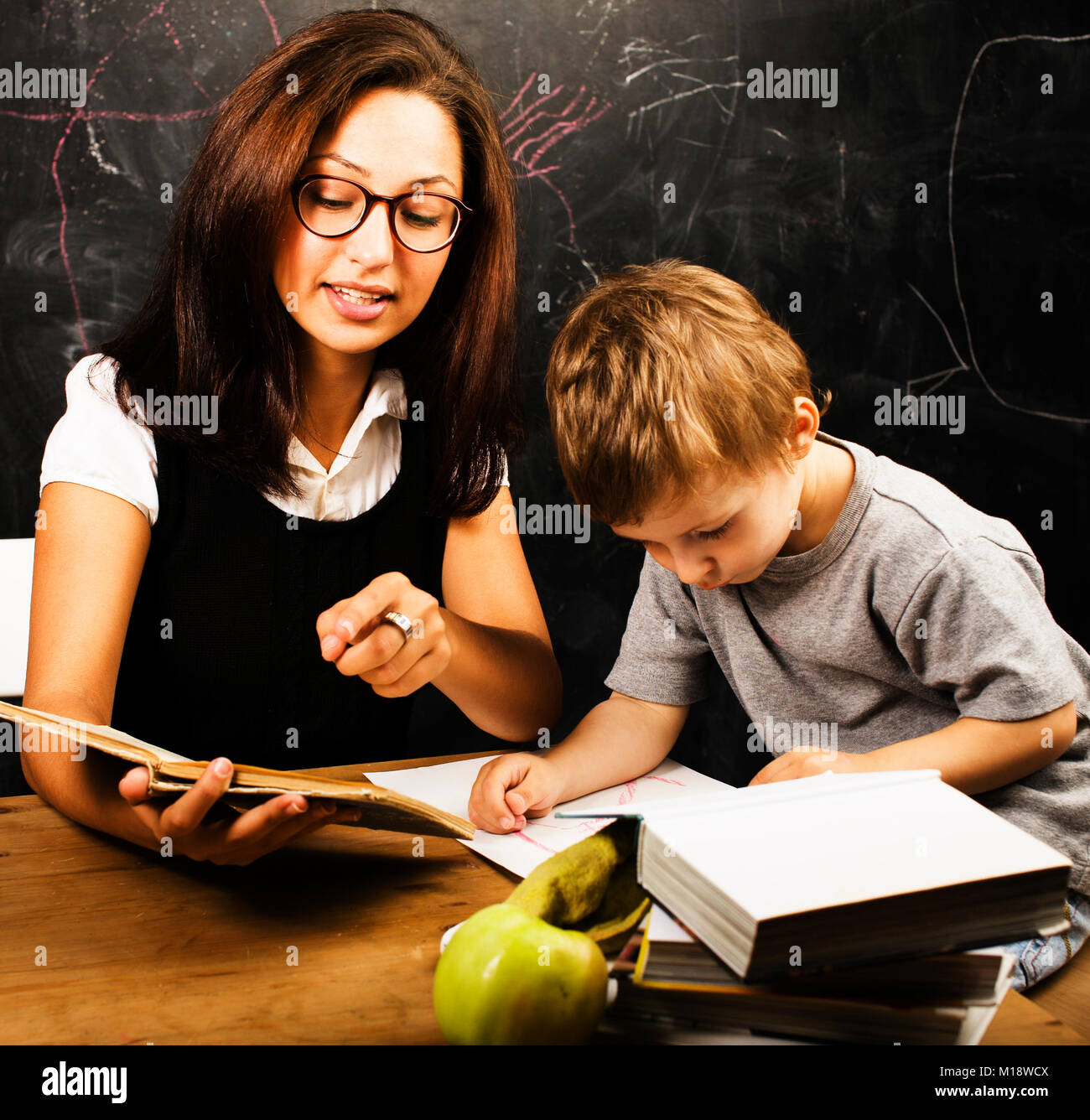 little cute boy with teacher in classroom Stock Photo - Alamy