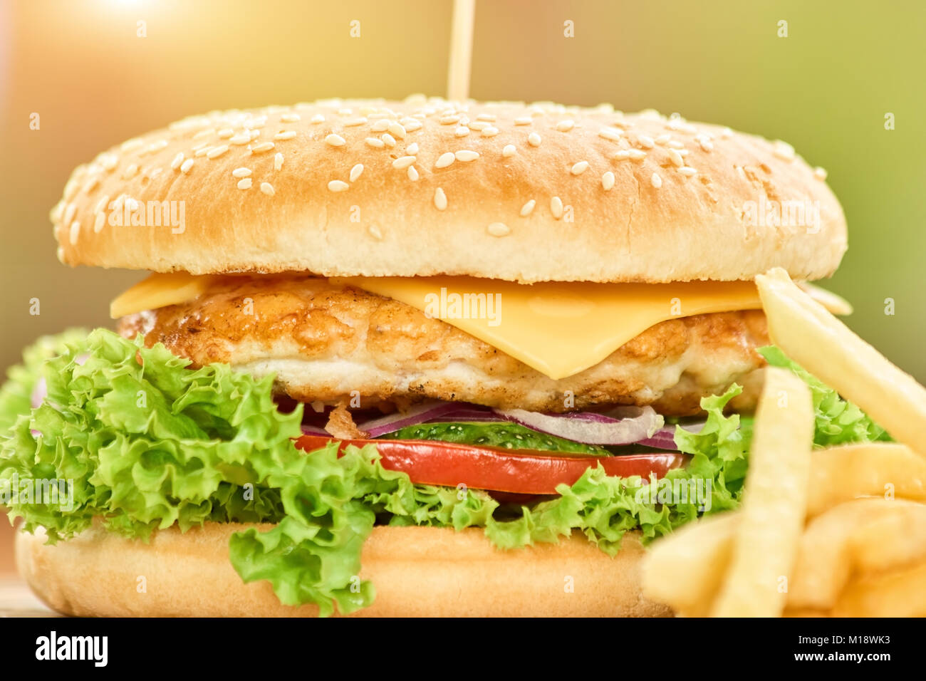 Close-up of a fast food burger containing meat topped with cheese ...