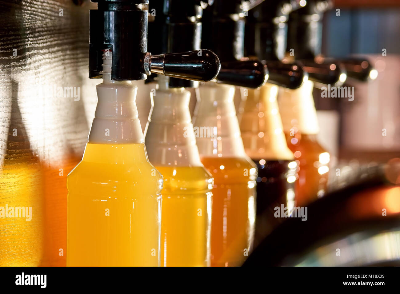 Beer taps beer pouring in bottles Stock Photo - Alamy