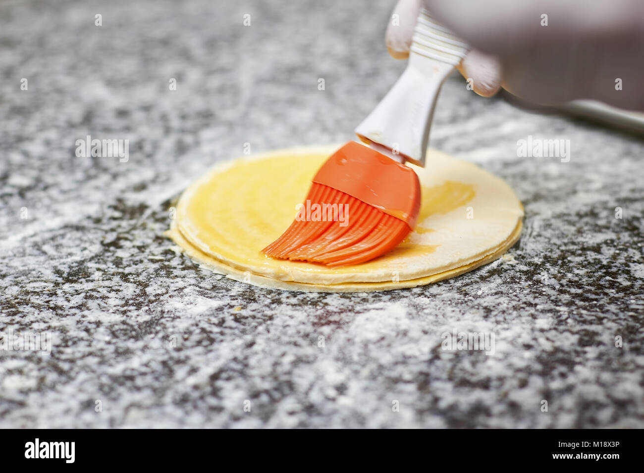 Greasing round dough close up Stock Photo - Alamy