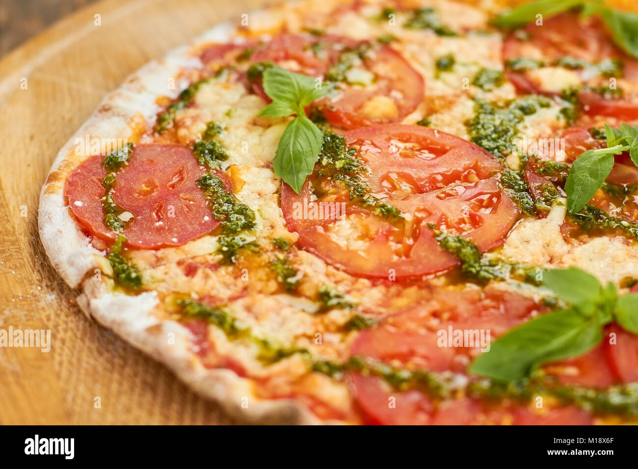 Thin Crust Tomato Pizza, close up Stock Photo - Alamy