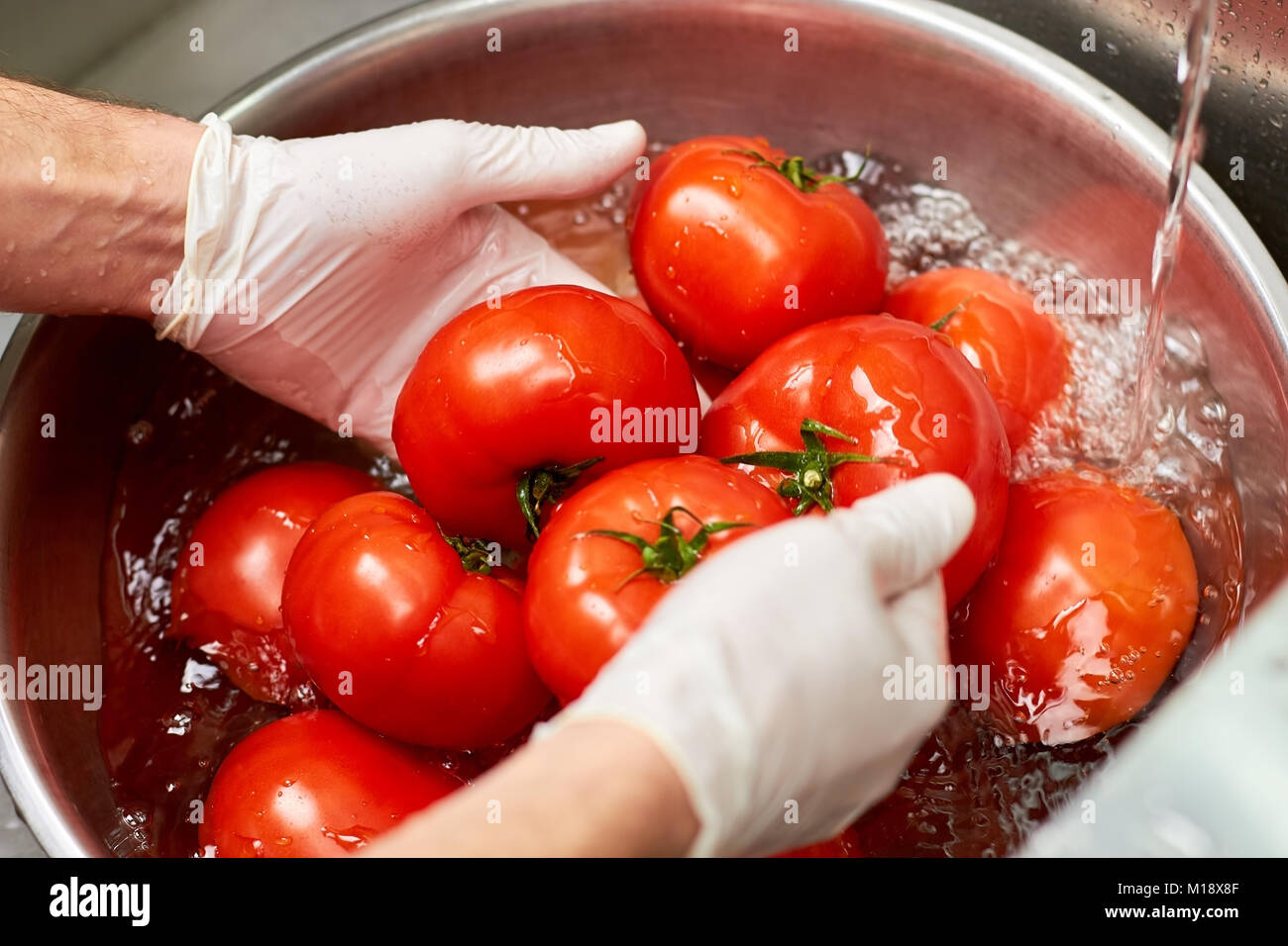 Chef washing tomatoes in water, close up Stock Photo - Alamy
