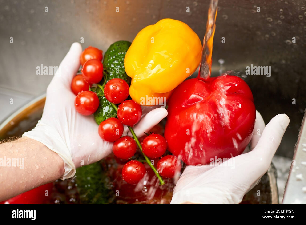 Chef washing bell peppers and cherry tomatoes Stock Photo - Alamy
