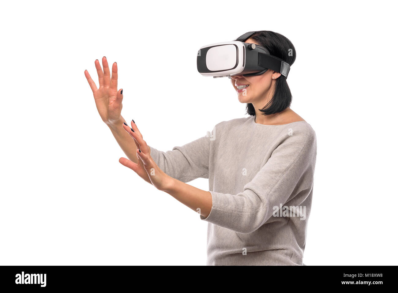 Young woman in a virtual reality helmet on a white Stock Photo - Alamy
