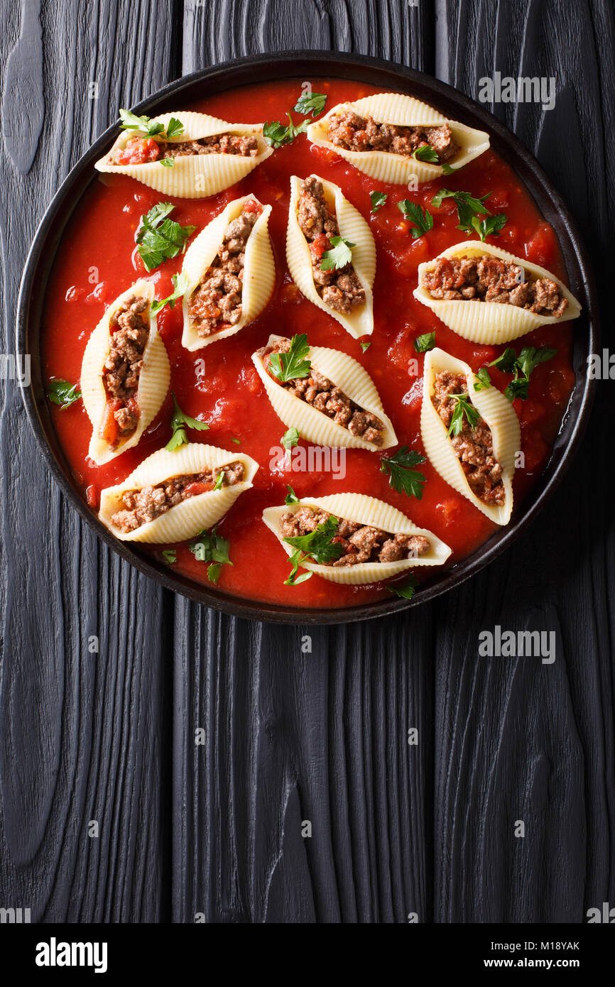 Shells pasta stuffed with ground beef with herbs in a marinara sauce ...
