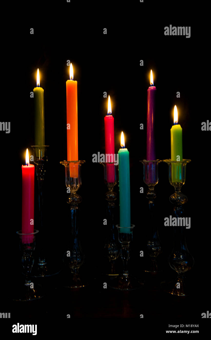 Many coloured candles in glass candlesticks Stock Photo - Alamy
