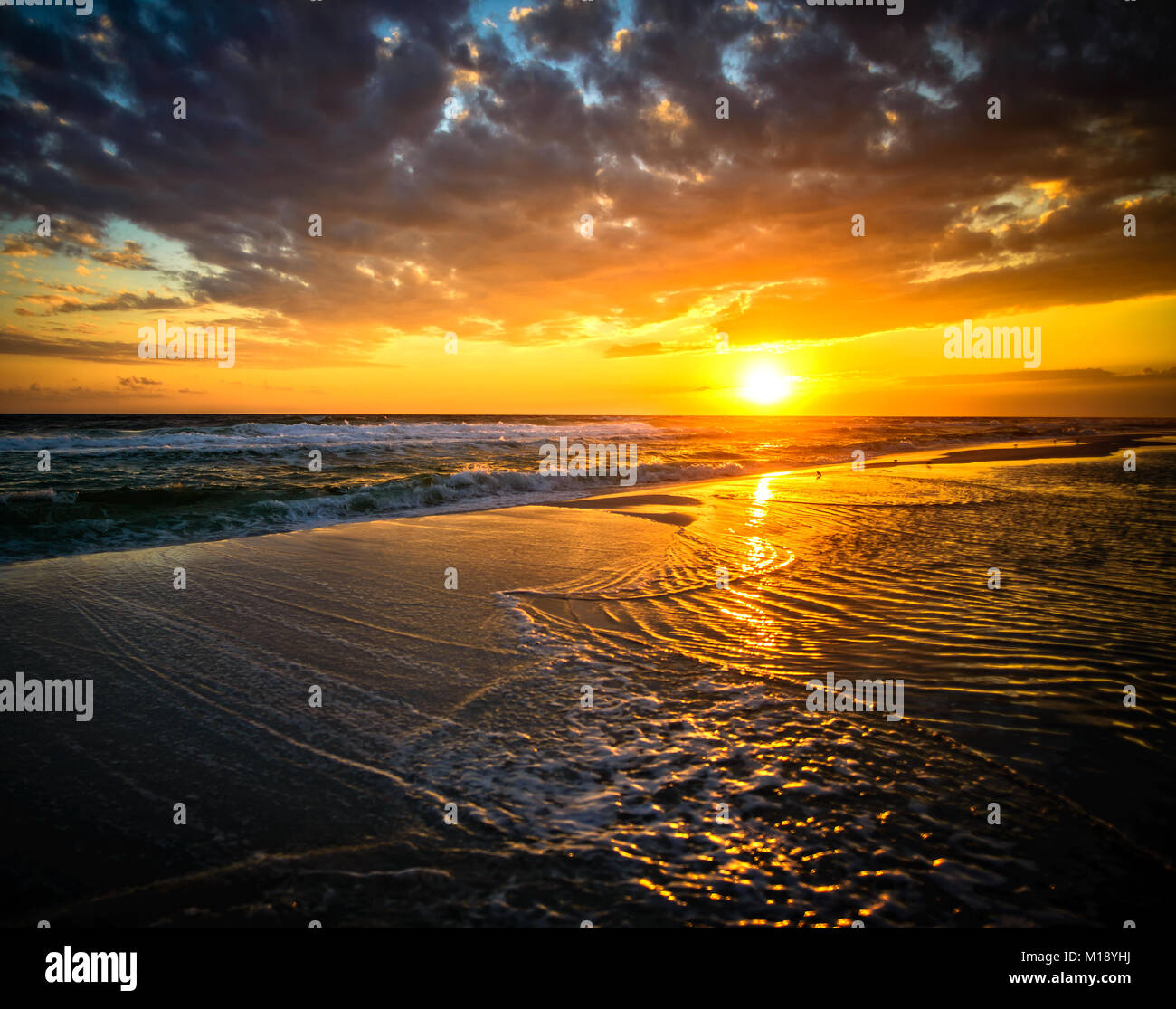 Sun over ocean with ripples Stock Photo - Alamy