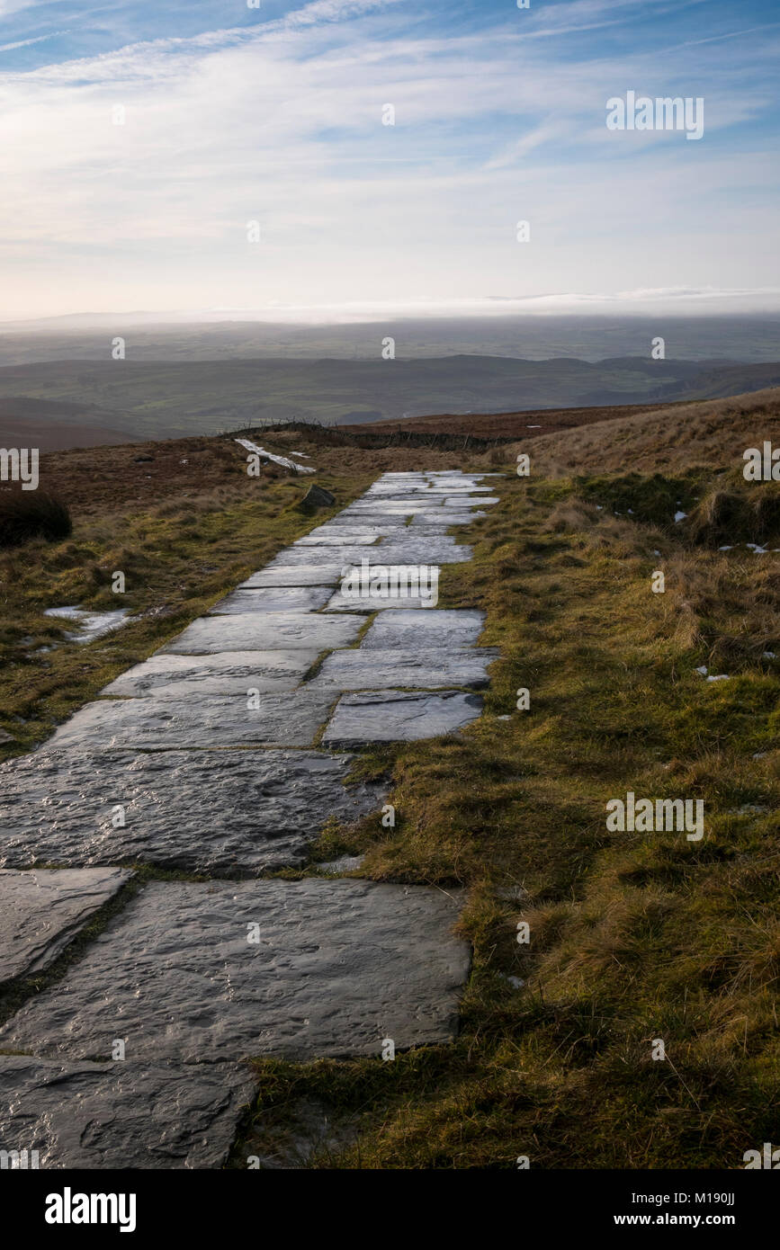 Looking along a paved path section of the Pennine Way from the top of ...