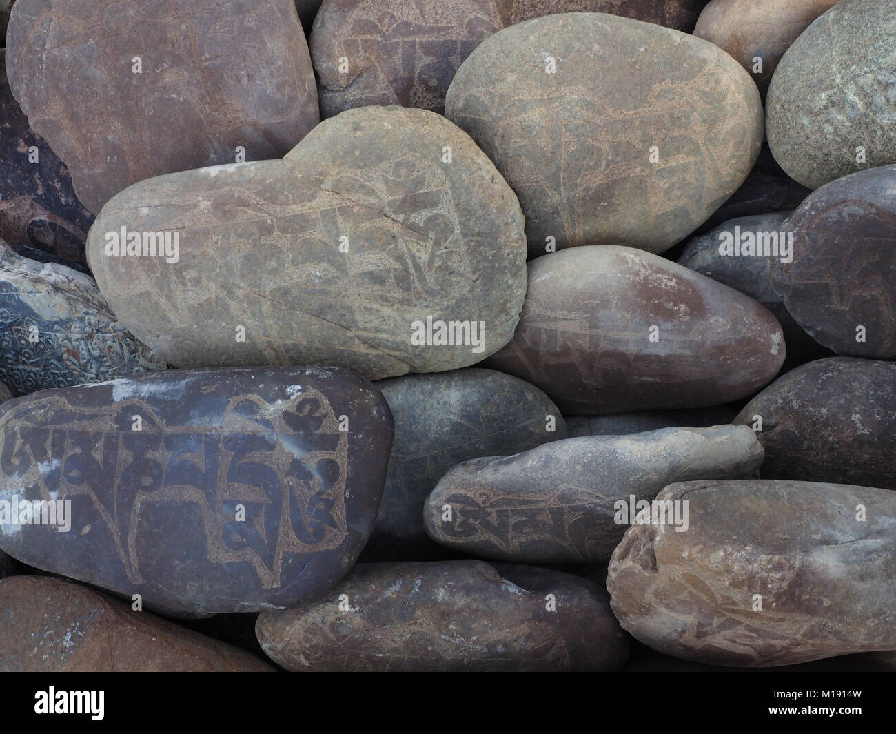 Buddhist prayer stones: on the river rounded boulders are painted ...