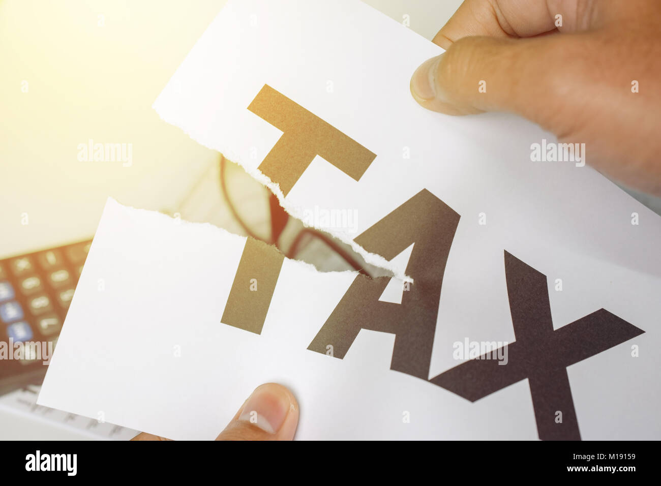 'Reduce Tax' man hands ripped paper with the word tax. business concept ...