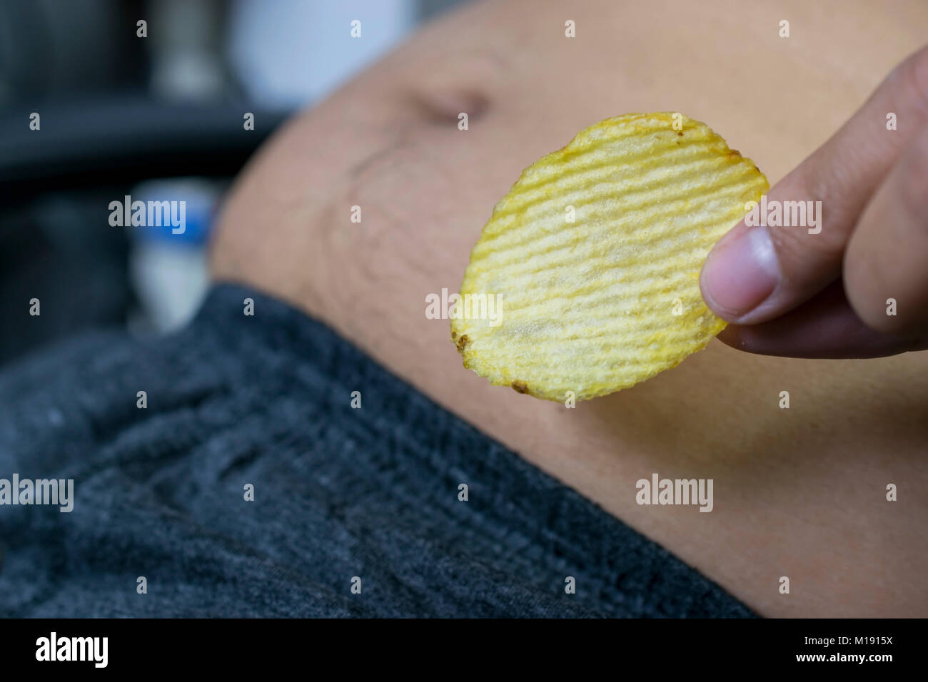 Fat man eating chips hi-res stock photography and images - Alamy