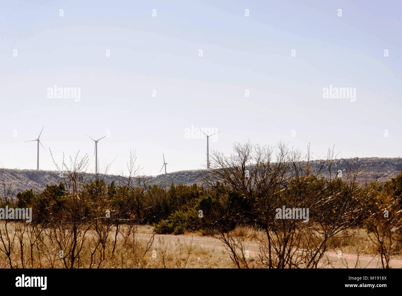 wind turbines in the desert with a blue sky Stock Photo - Alamy