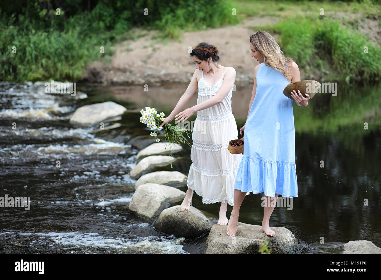 Beautiful girls in dresses on the river Stock Photo - Alamy