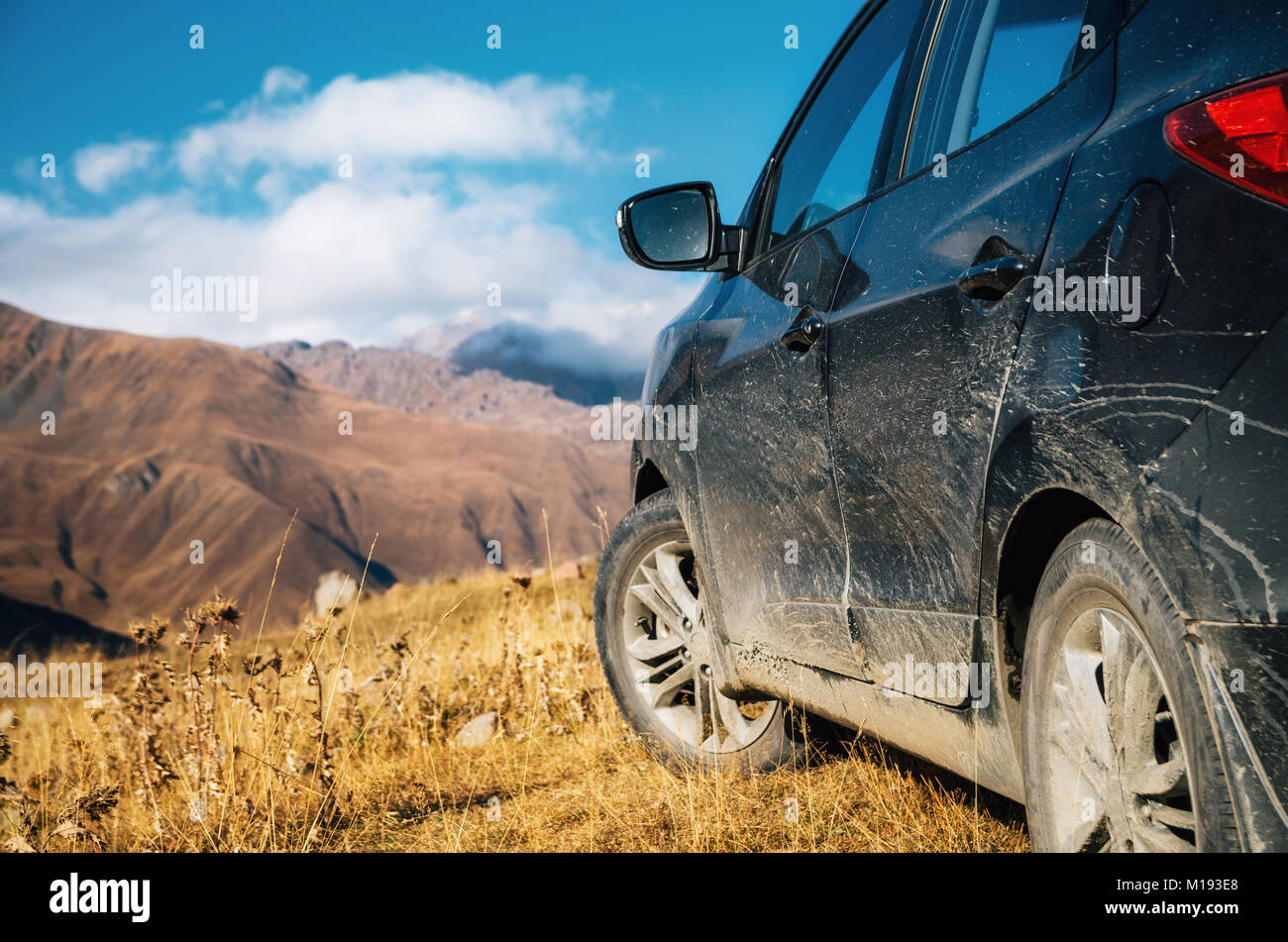 Off-road travel on car on mountain road against rocks in Caucasus ...