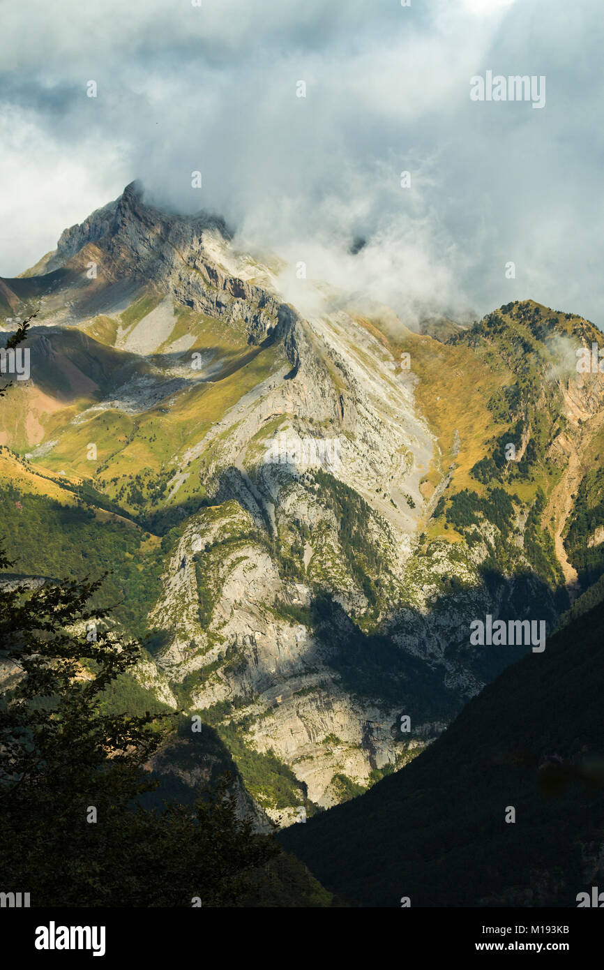 Contorted limestone strata below cloud shrouded 2709m Otal Peak above ...