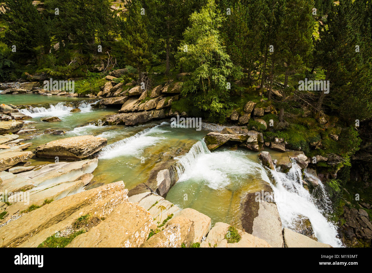 Steps of limestone strata make a waterfall on the Rio Arazas in the ...