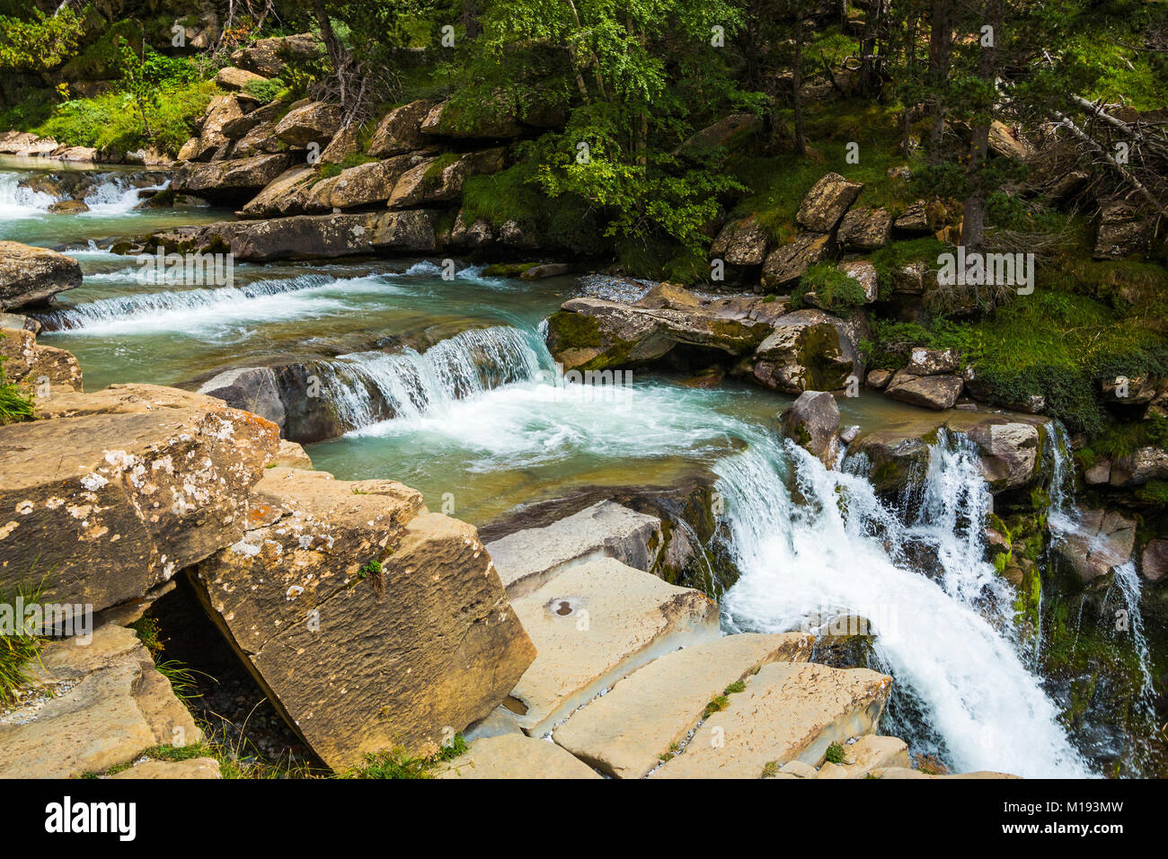 Steps of limestone strata make a waterfall on the Rio Arazas, upper ...